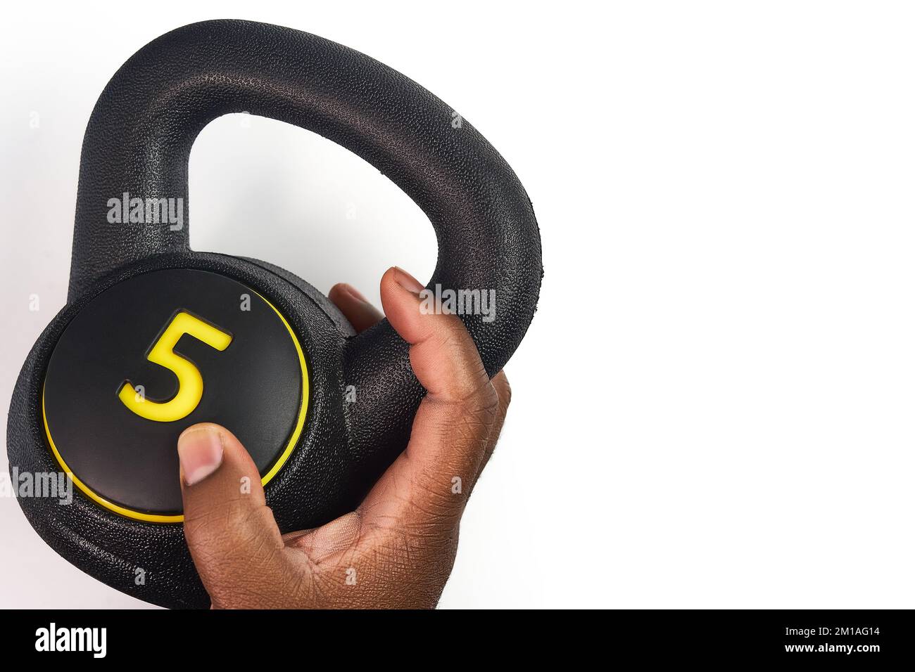 man holding a 5 pound kettle bell weight muscle building exercise ...