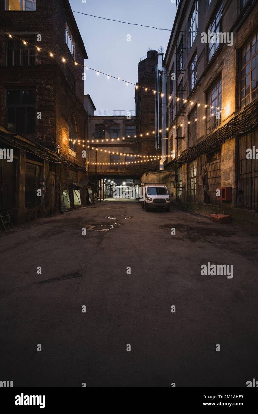 Dark street in an industrial area illuminated by small lanterns Stock ...