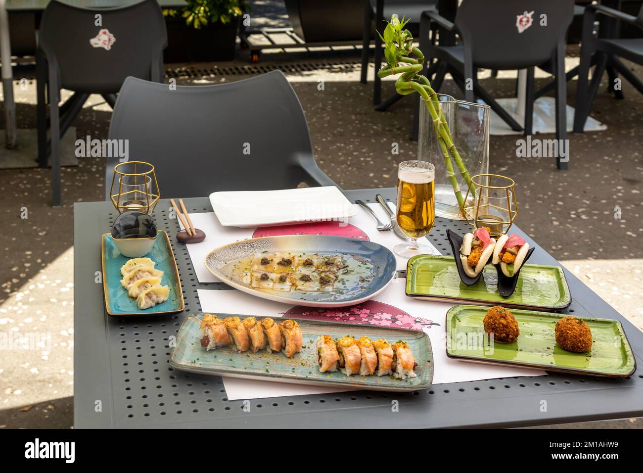 A high-angle shot of different types of traditional Asian dishes served ...