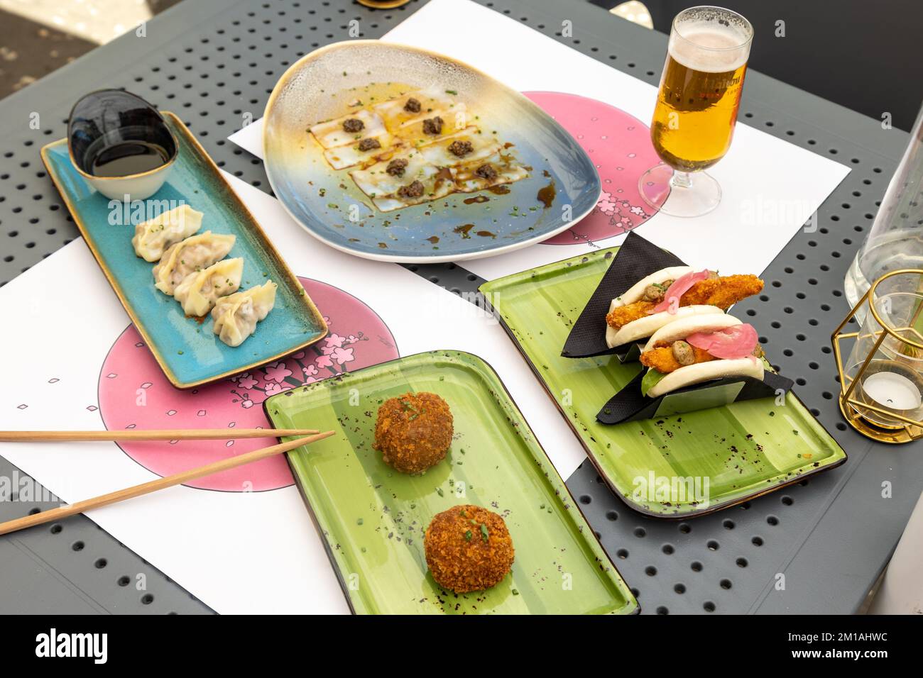 A high-angle shot of different types of traditional Asian dishes served ...