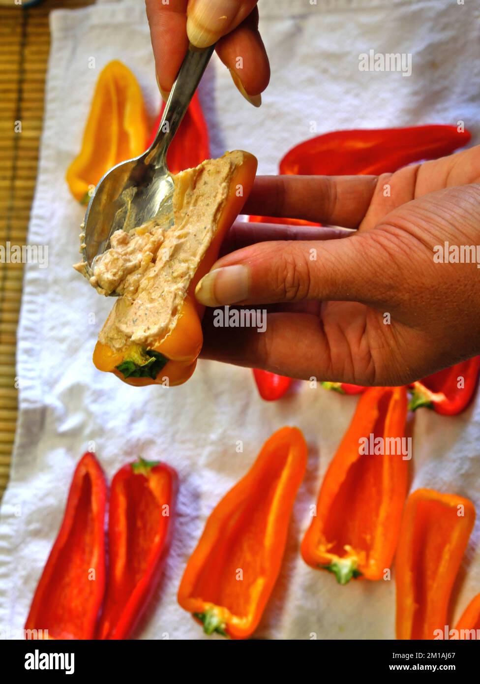 A vertical shot of making the Jalapeno poppers dish with red peppers ...