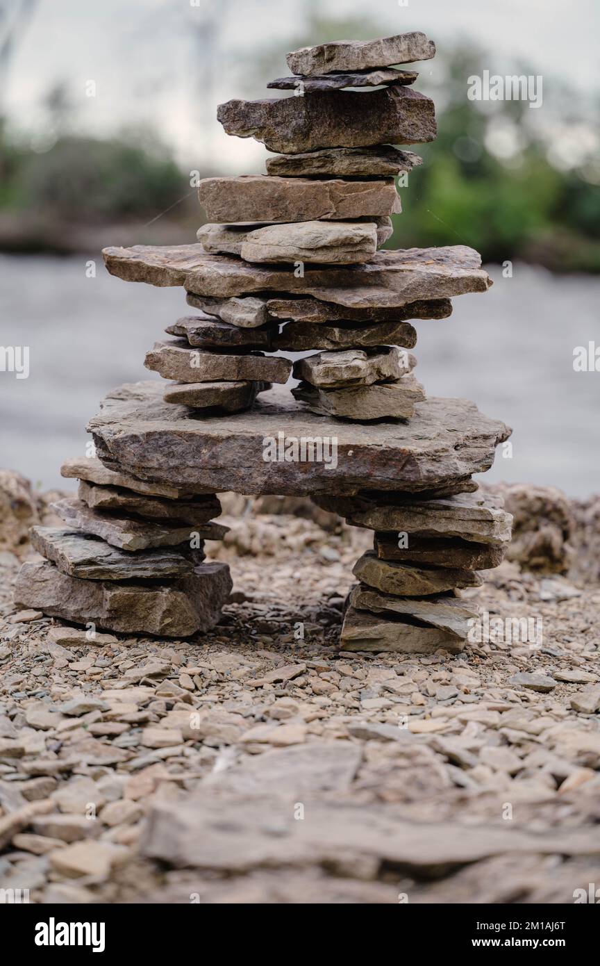 A vertical shot of rocks balanced on each other on the blurred ...