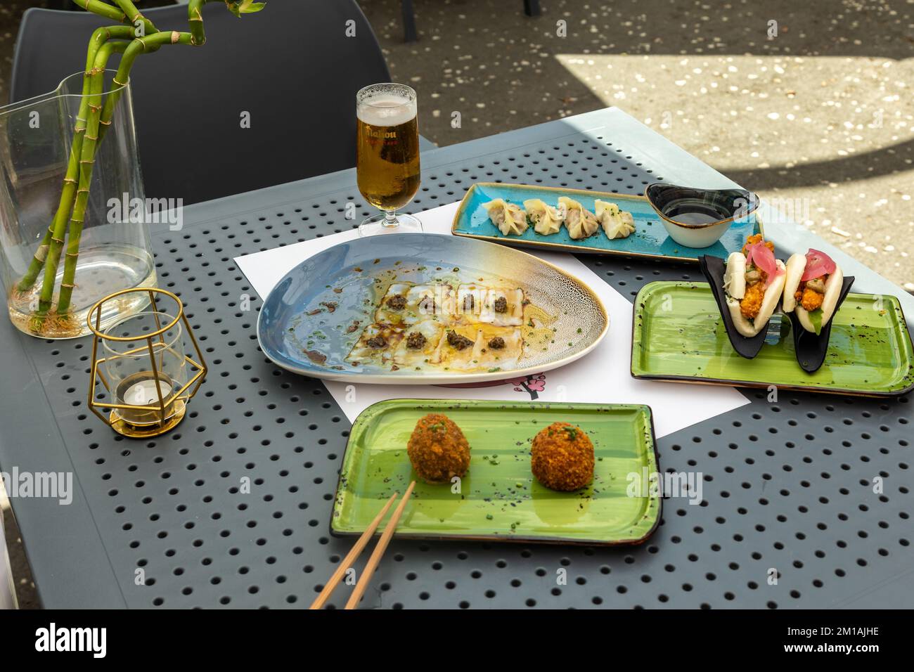 A high-angle shot of different types of traditional Asian dishes served ...