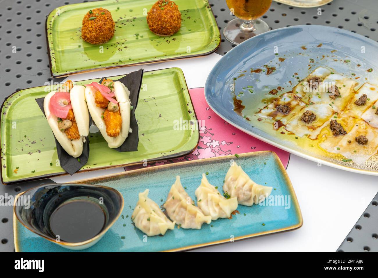 A high-angle shot of different types of traditional Asian dishes served ...