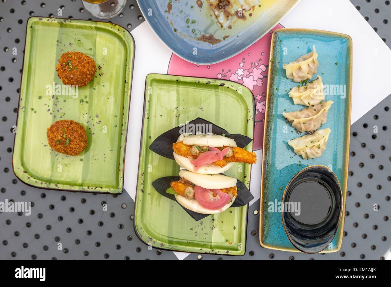 A top view of different types of traditional Asian dishes served at a ...