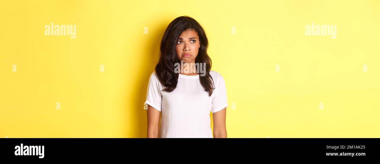 Portrait of sad and disappointed african-american woman, sulking and ...