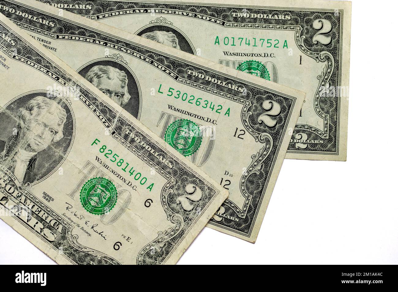 Three USD Two 2 Dollar Bills on a white background Stock Photo - Alamy