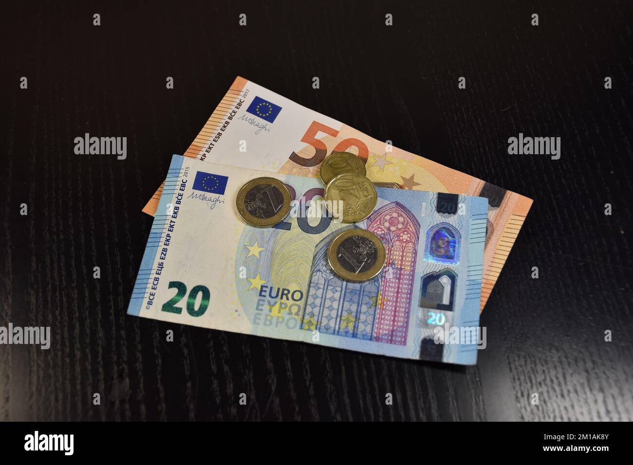 Euros in black background, banknotes and coins Stock Photo - Alamy