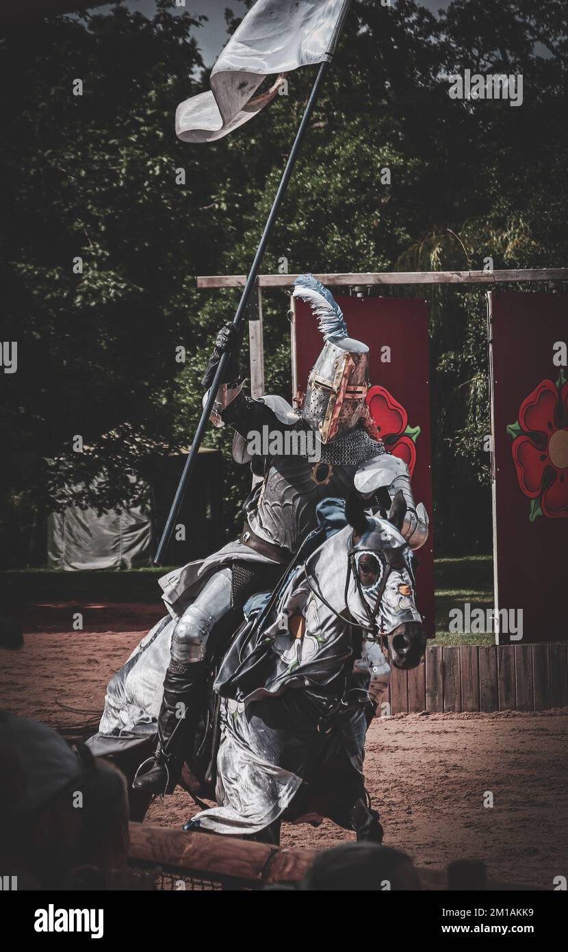 A vertical closeup of a knight on a horse during a medieval jousting ...