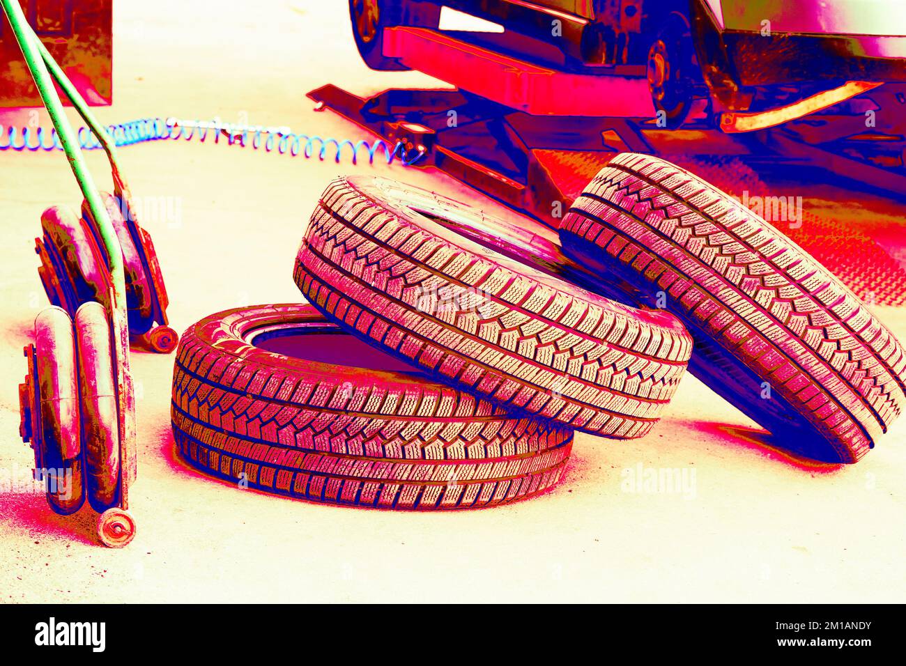 Red neon replacing a car wheel at a tire station Stock Photo - Alamy