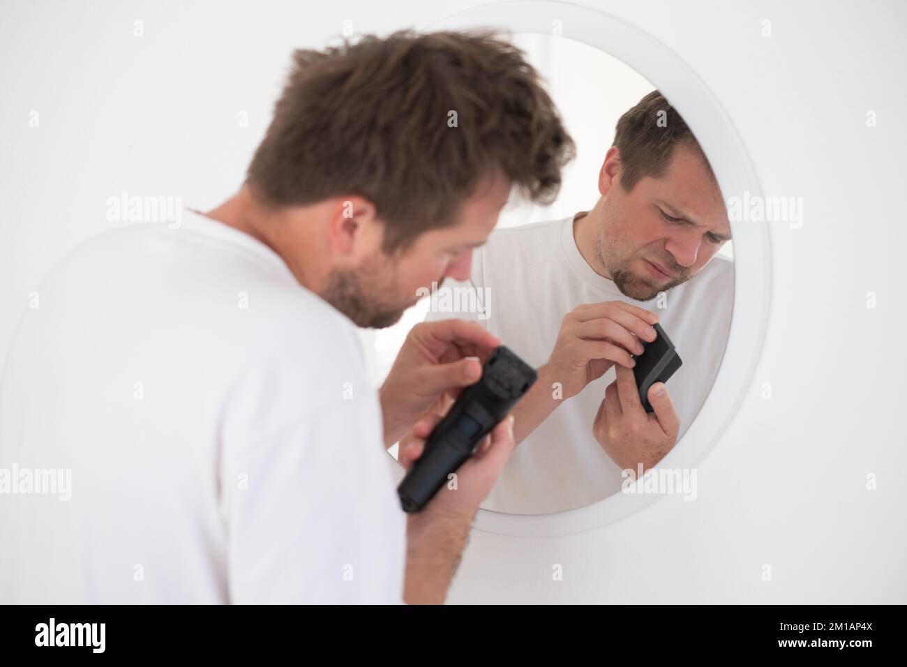 man tries to understand what happened to his razor while cutting his ...