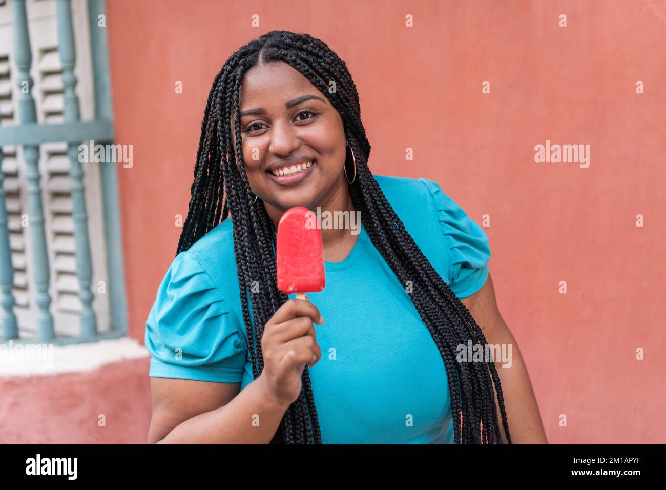 Young Woman Eating Popsicle On The Street Stock Photo - Alamy