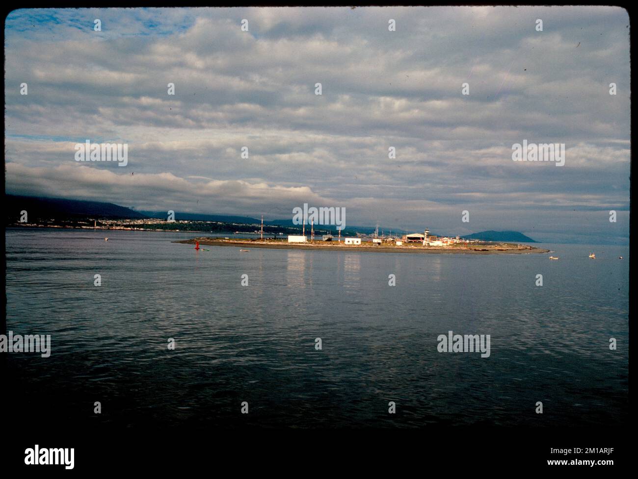 View across body of water toward small island and opposite shore ...