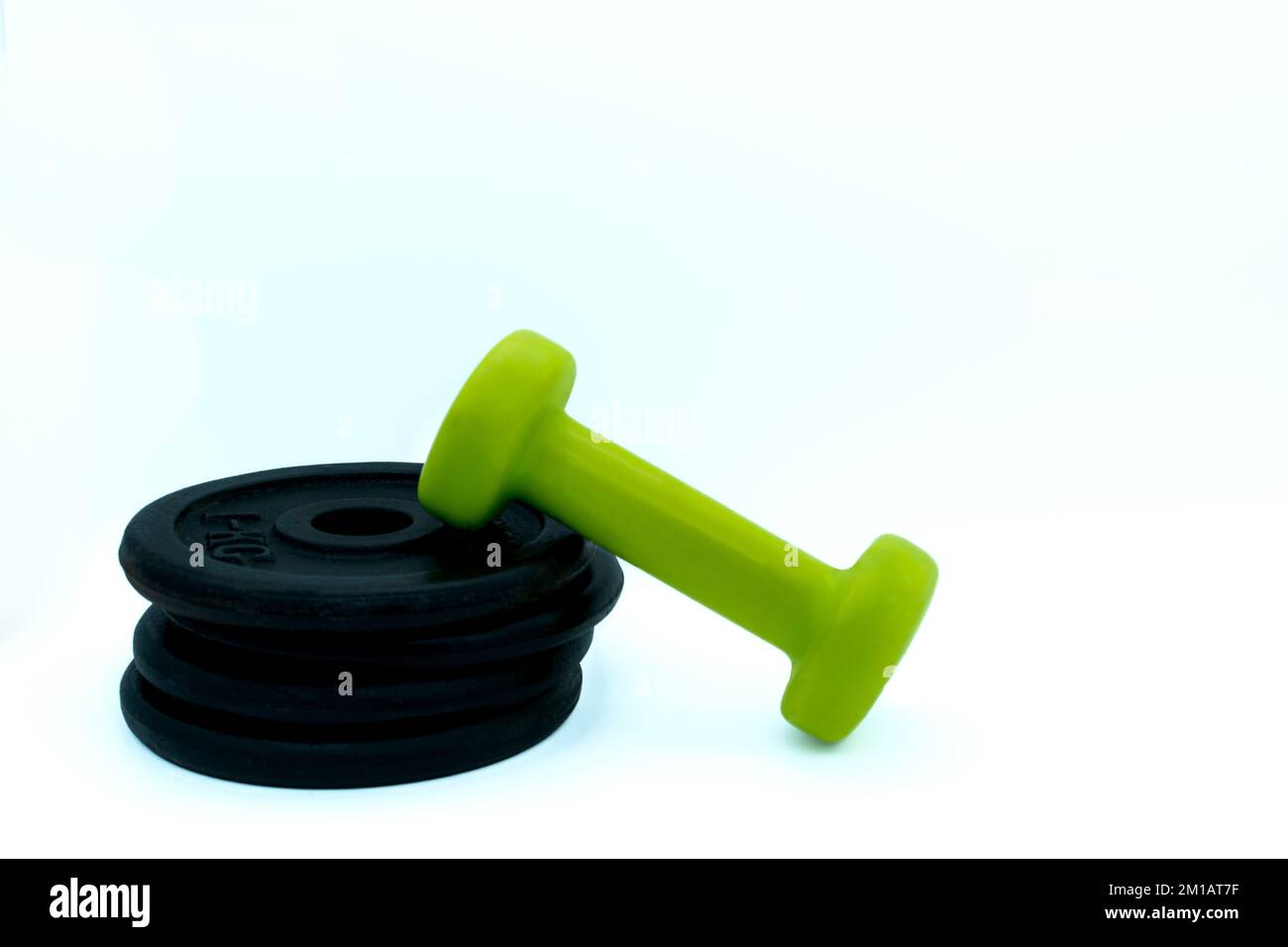 disc weights with a dumbbell on top on a white background Stock Photo ...
