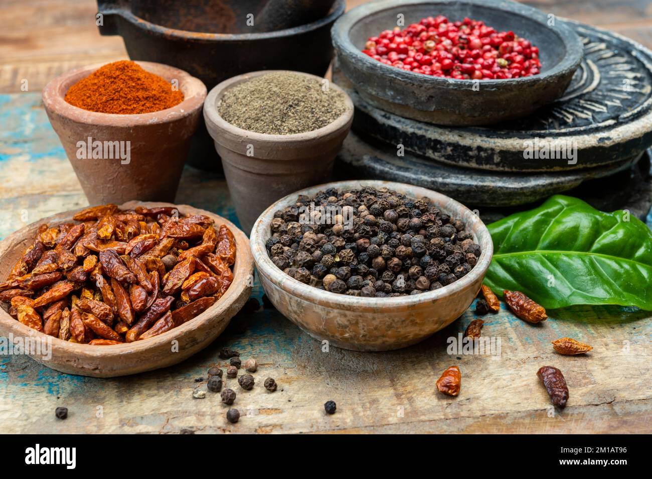 Colorful ground spicy chili peppers , pimento and curcuma is clay pots ...