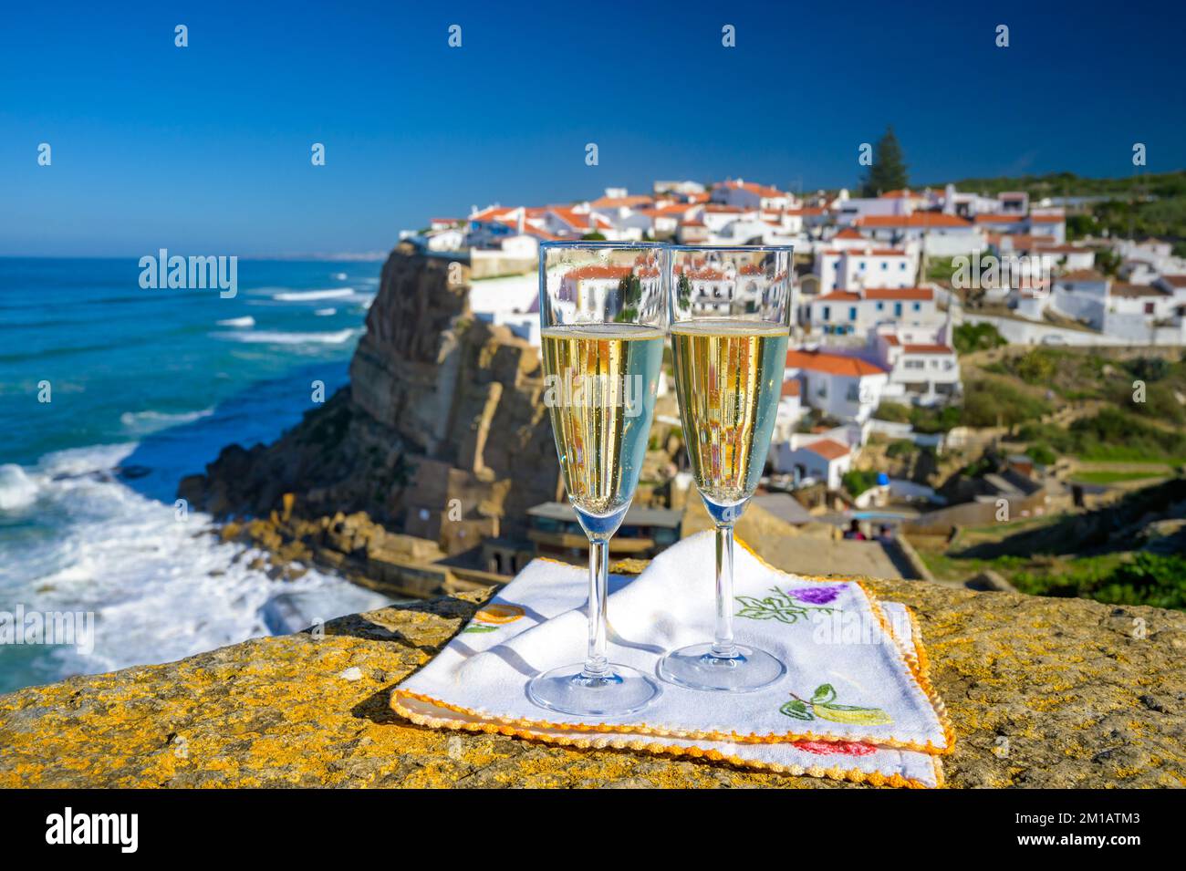 Glasses of champagne sparkling white wine and view on white houses of ...
