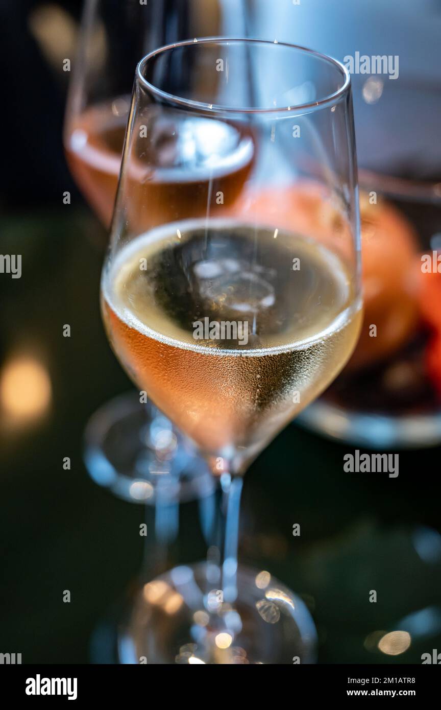 Tasting of brut and rose champagne sparkling wine produced by traditional method in underground ...