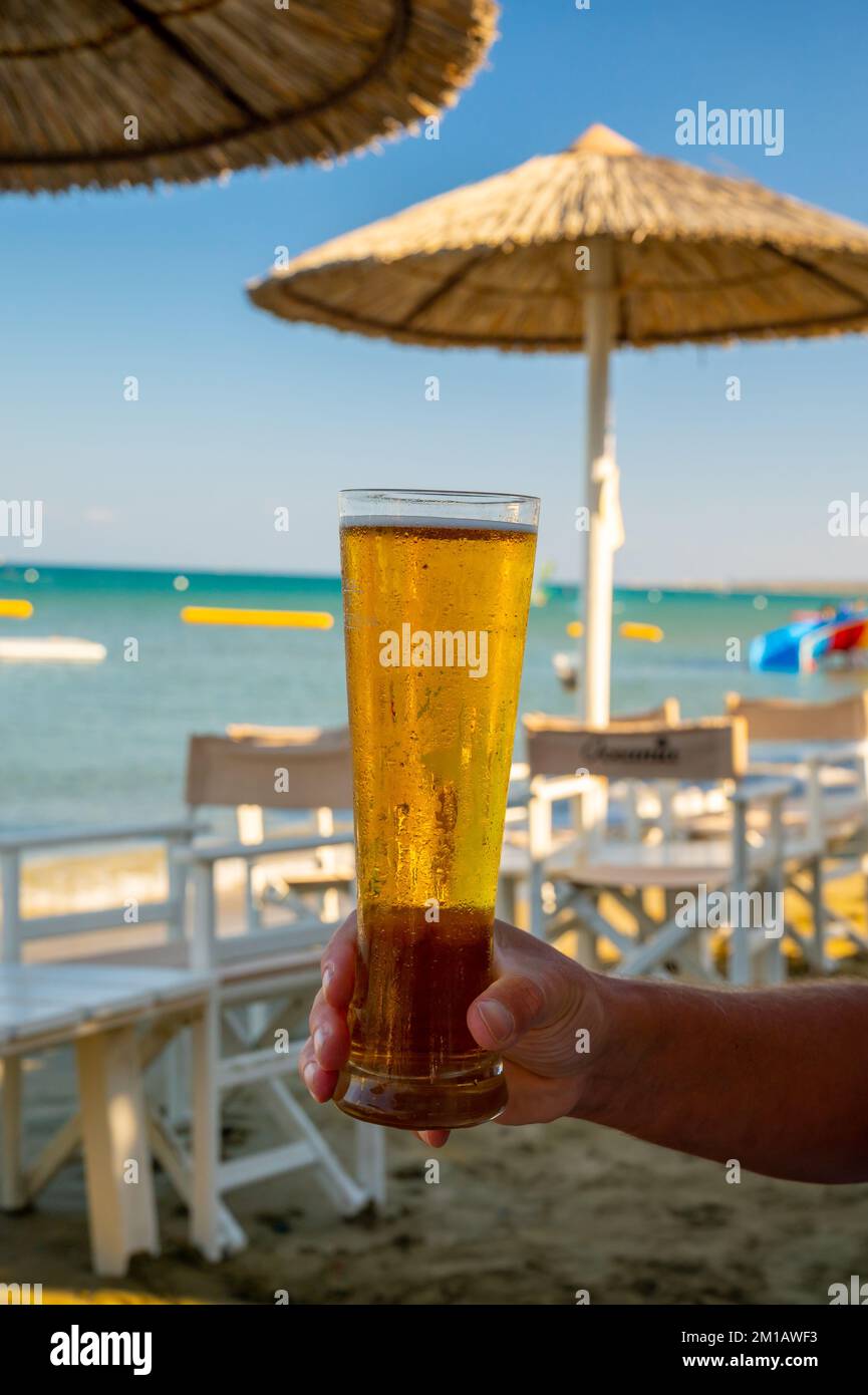 Pint of cold lager beer served outdoor in sunny beach bar on Cyprus ...
