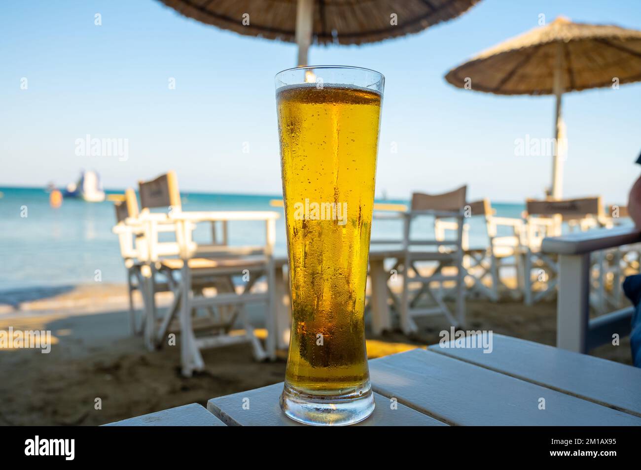 Pint of cold lager beer served outdoor in sunny beach bar on Cyprus ...