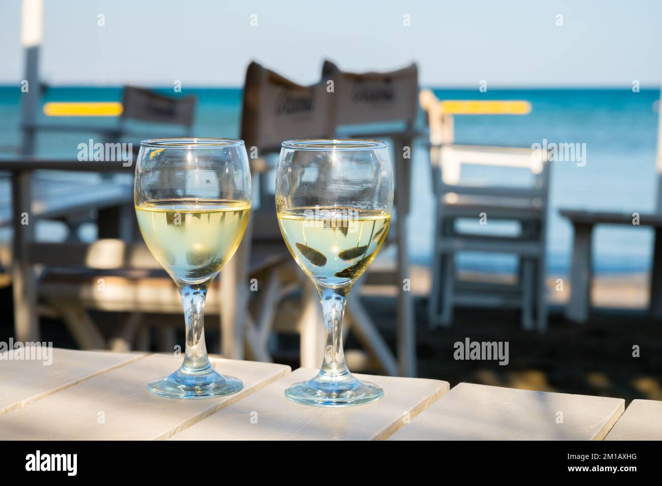 Drinking of cold white wine in beach bar, summer holidays, relax on ...