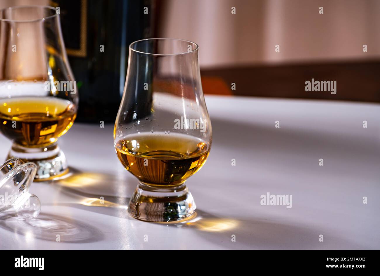 Tasting of whiskey, tulip-shaped tasting glasses with dram of Scotch ...