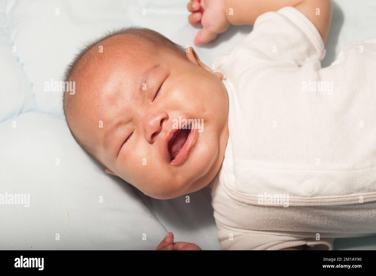 Newborn Asian baby girl lying and happiness on a bed Stock Photo - Alamy