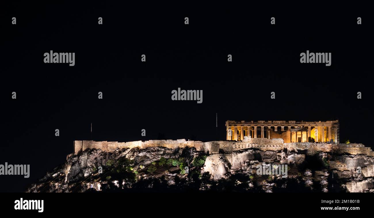 A scenic shot of the Parthenon at night in Acropolis, Athens, Greece ...