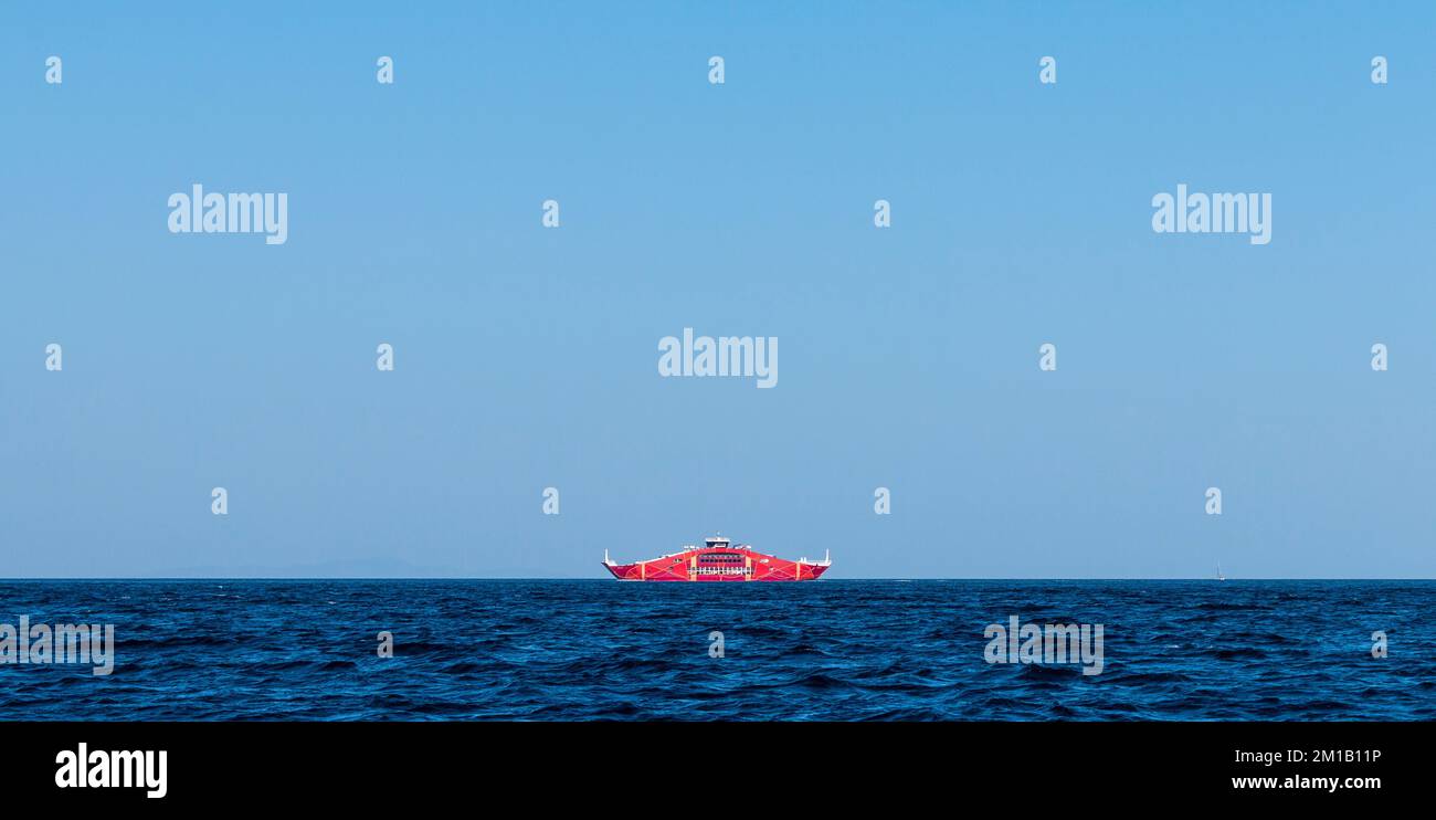 A red ship on the sea surface under the blue sky Stock Photo - Alamy