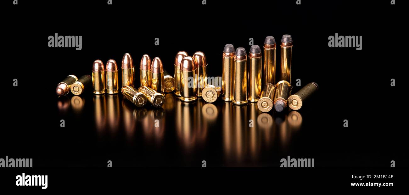 Bullet isolated on black background with reflexion. Rifle bullets close ...