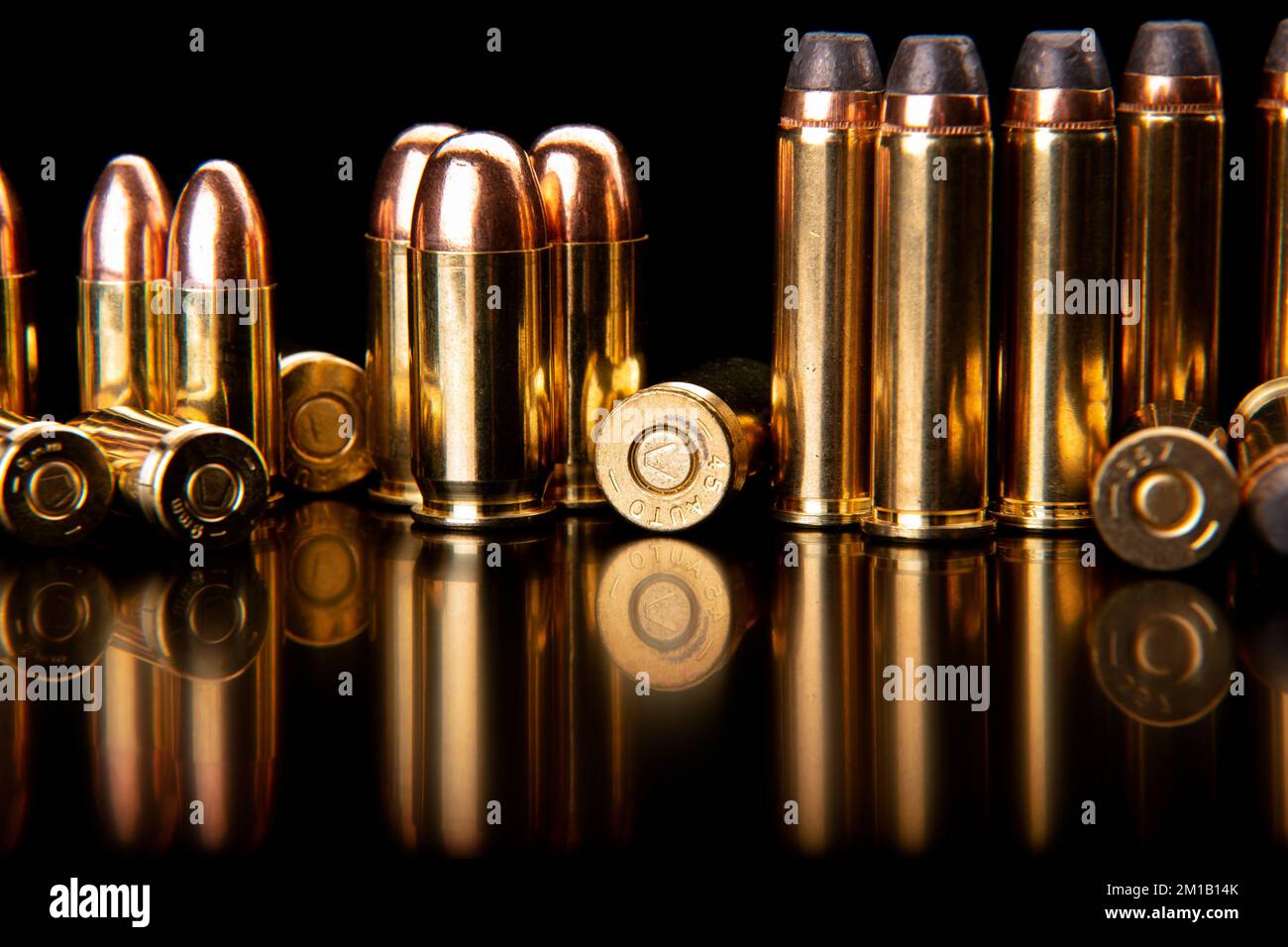 Bullet isolated on black background with reflexion. Rifle bullets close ...