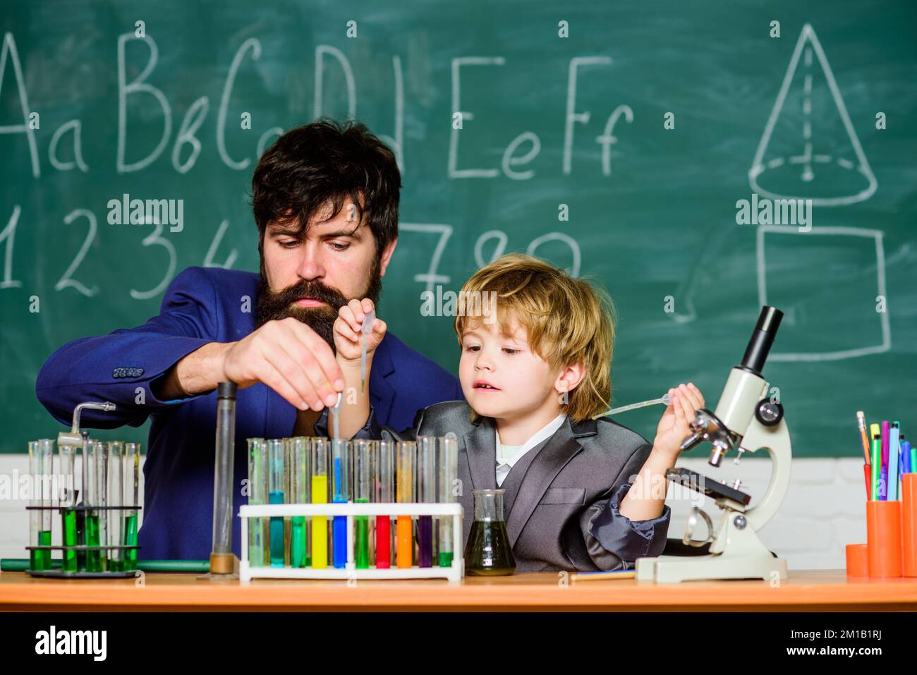 Chemistry and physics biology. bearded man teacher with little boy ...