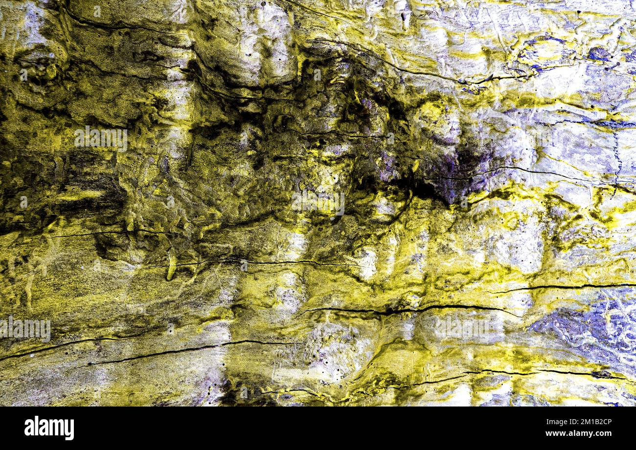 Weathered rock texture with yellow abstract reflections. Stone surface ...