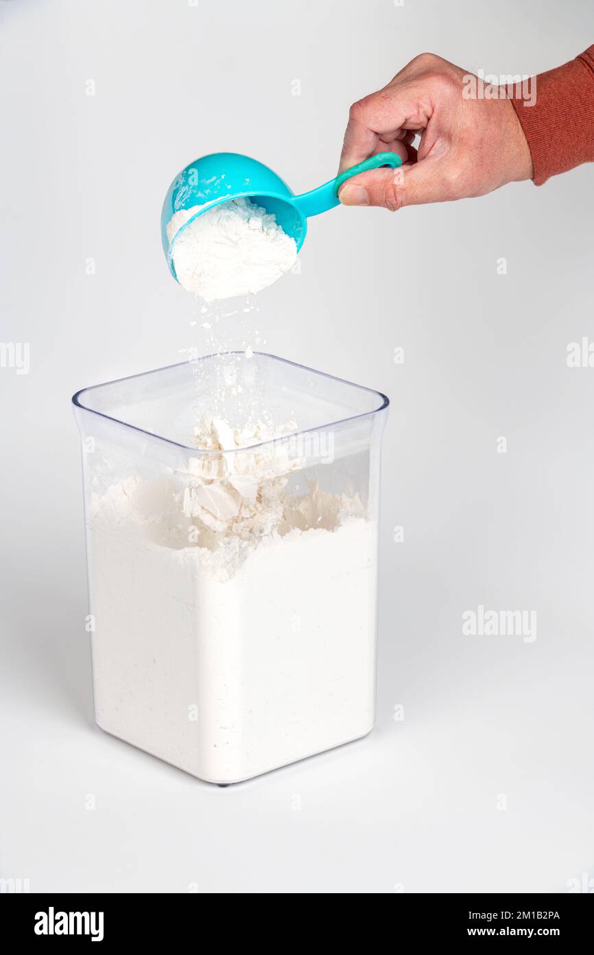 Flour storage container with blue scooper Stock Photo - Alamy