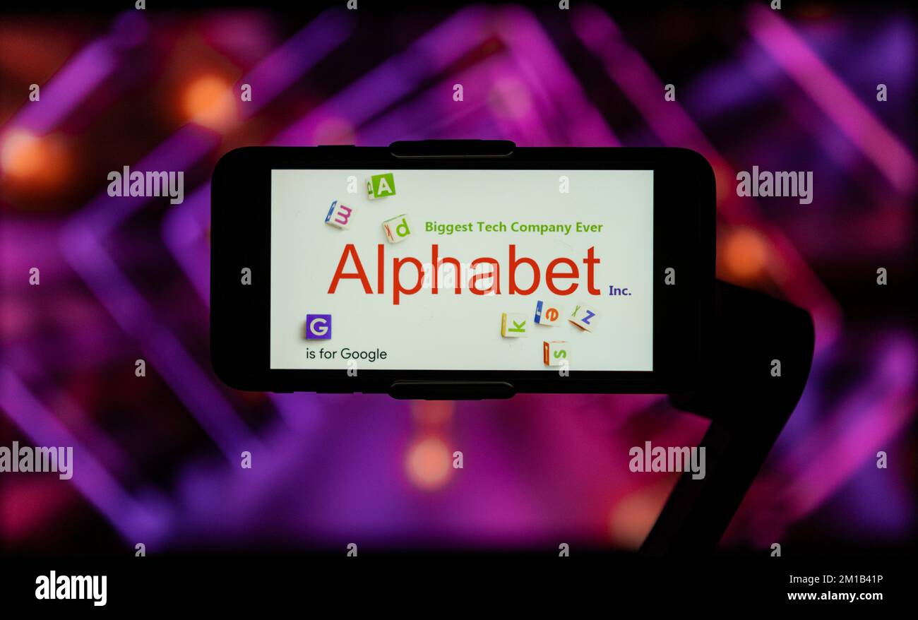 In this photo illustration, the logo of Alphabet is seen displayed on a ...