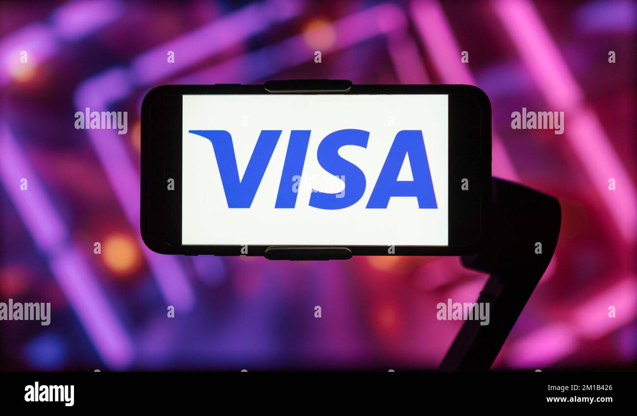 In this photo illustration, the logo of Visa is seen displayed on a ...