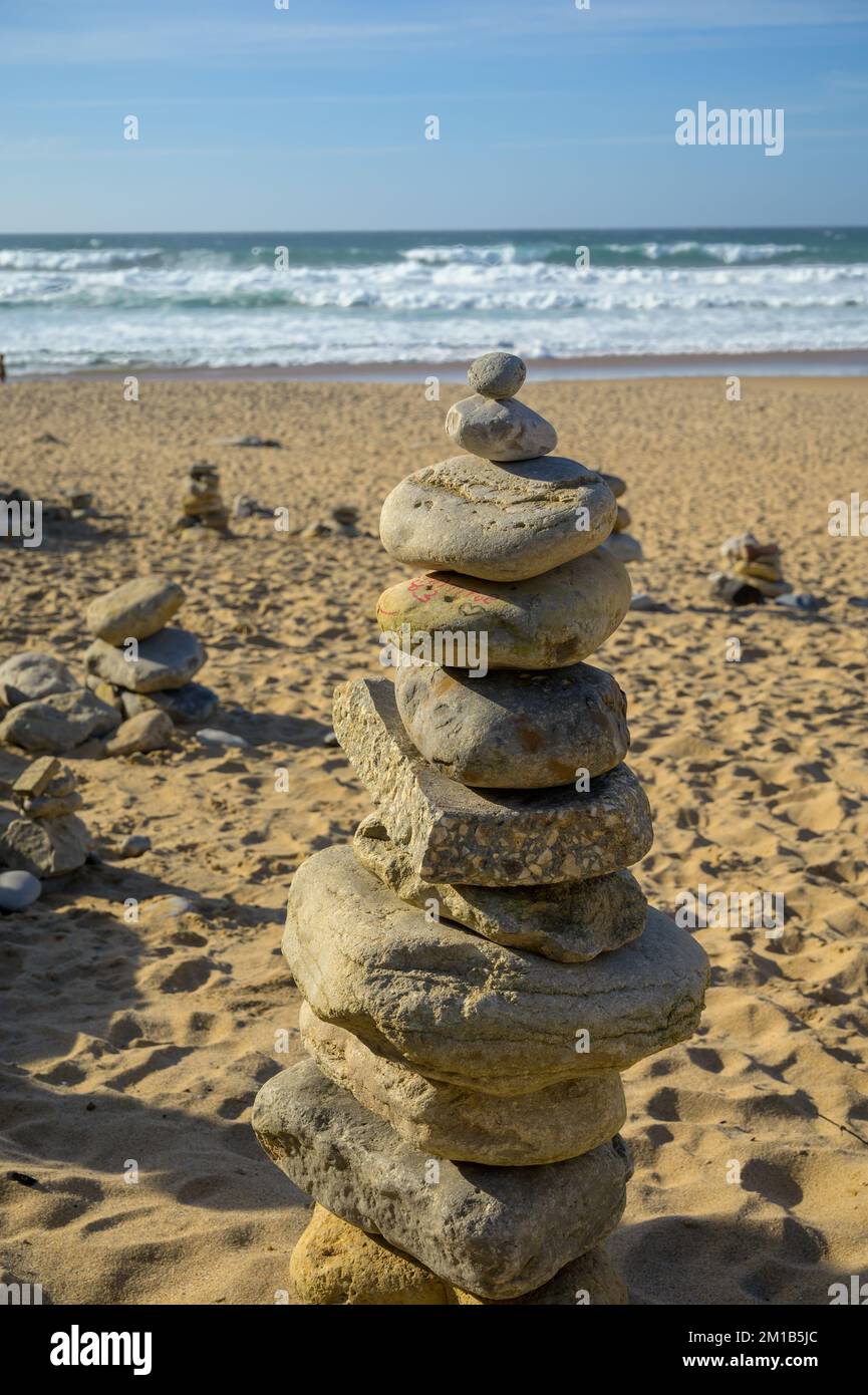 Pyramid from stack balanced stones on sandy beach in sunset, Atlantic ...