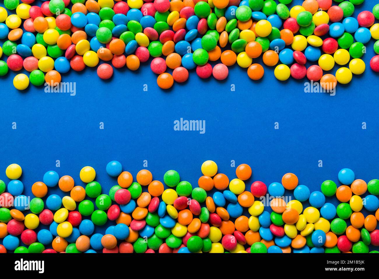 Mixed collection of colorful candy, on colored background. Flat lay ...