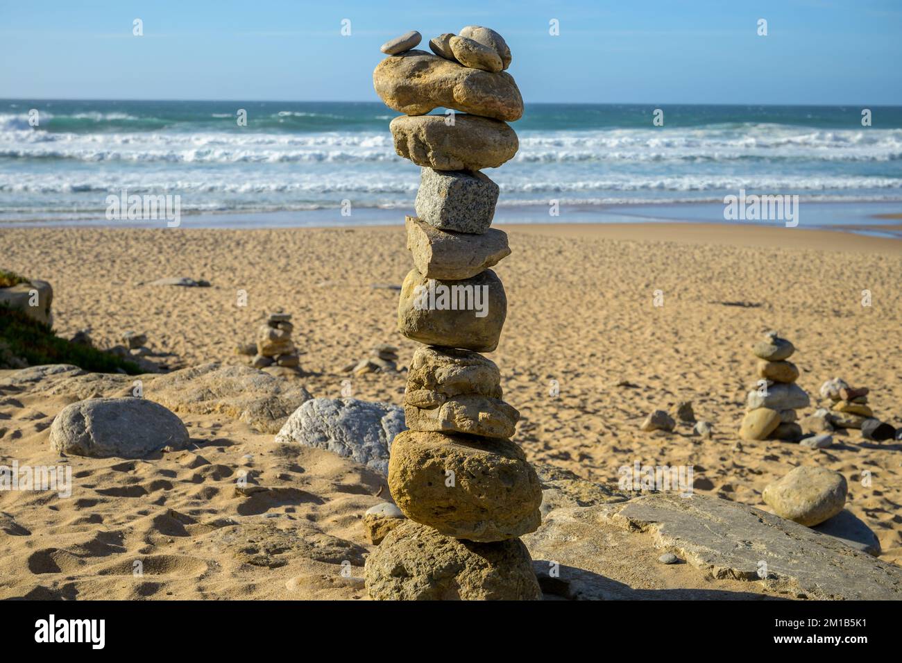 Pyramid from stack balanced stones on sandy beach in sunset, Atlantic ...