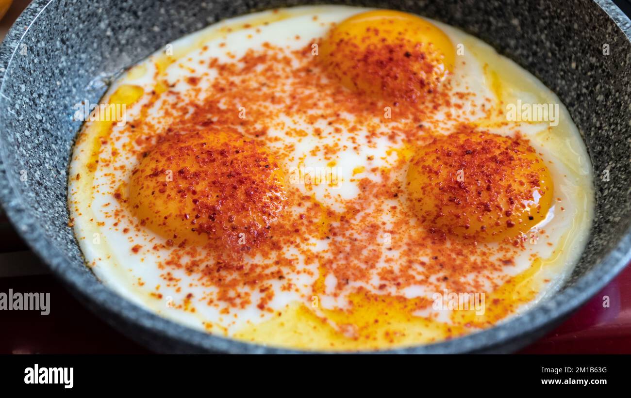 Sunny side up egg in the pan. Cooking eggs on the stove for breakfast ...