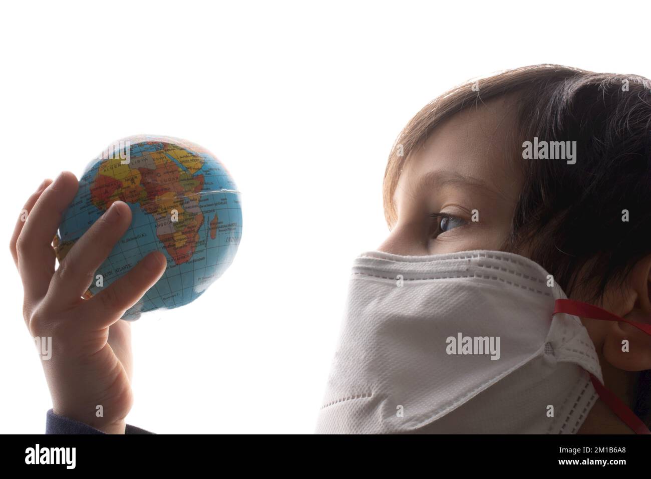 boy holding a globe isolated on a white background. Cute happy child ...