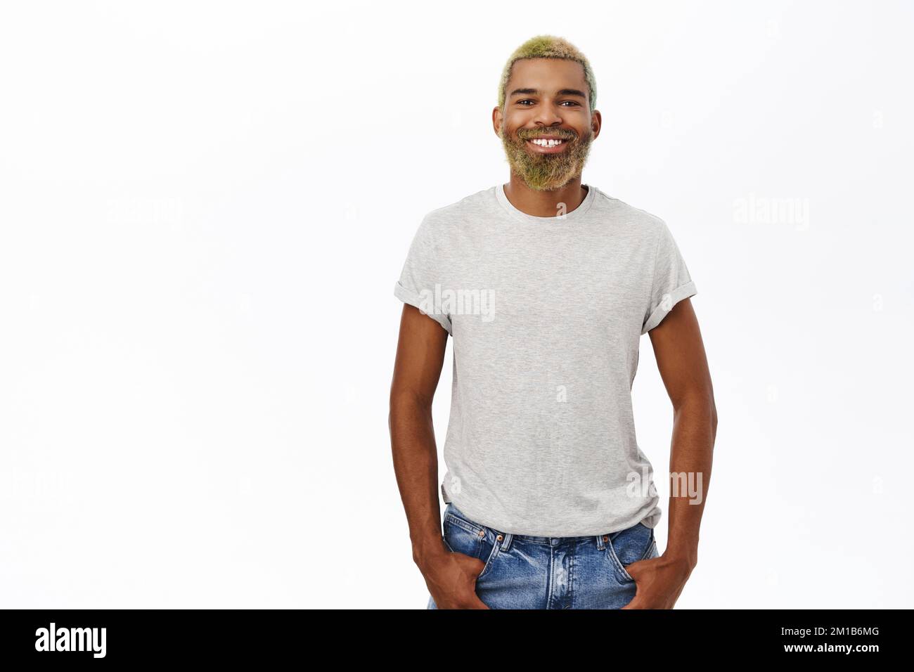 Smiling hipster guy with yellow beard and hair, looking happy and ...