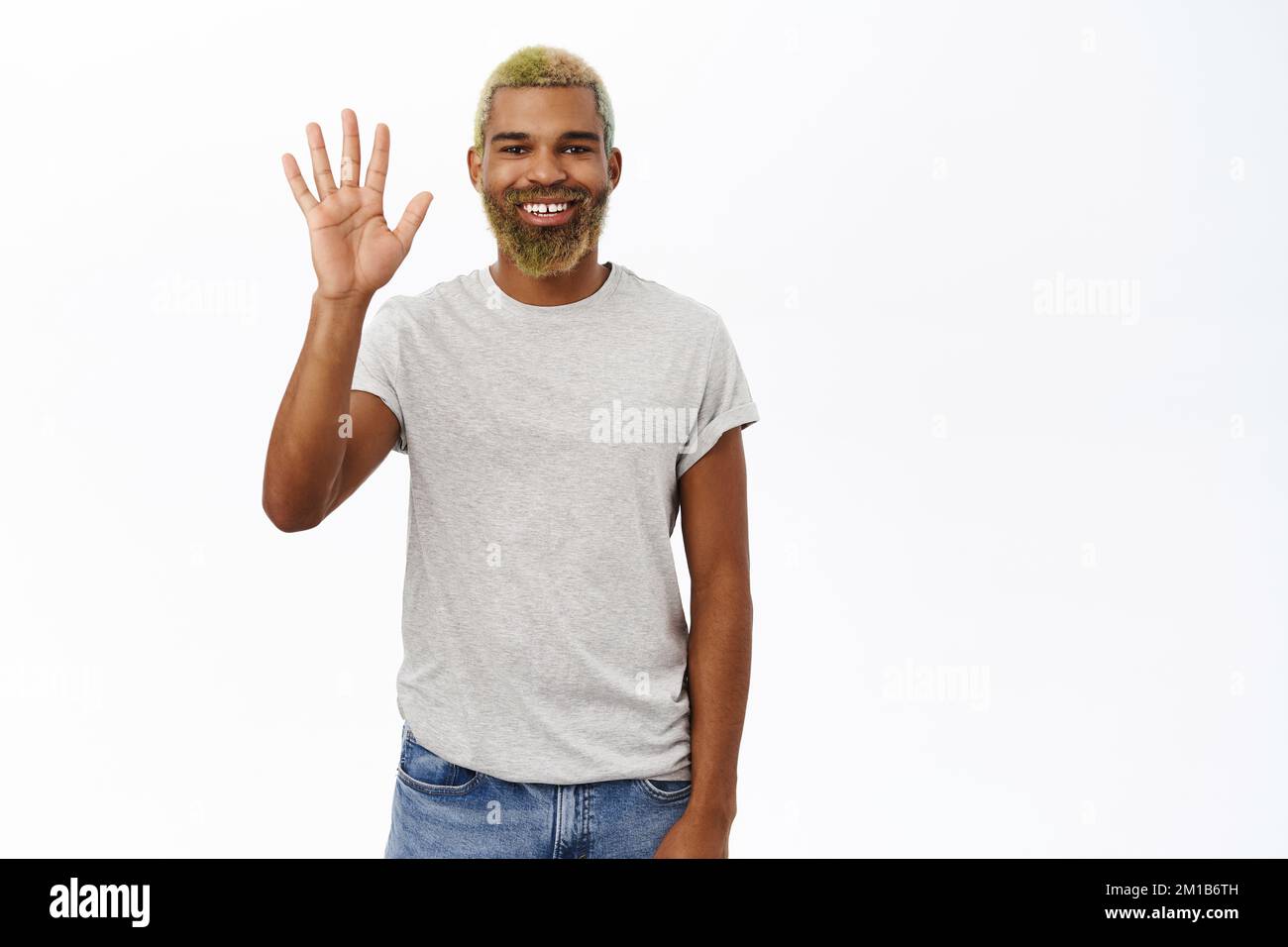 Friendly guy smiles and waves at you, says hello, hi gesture Stock ...