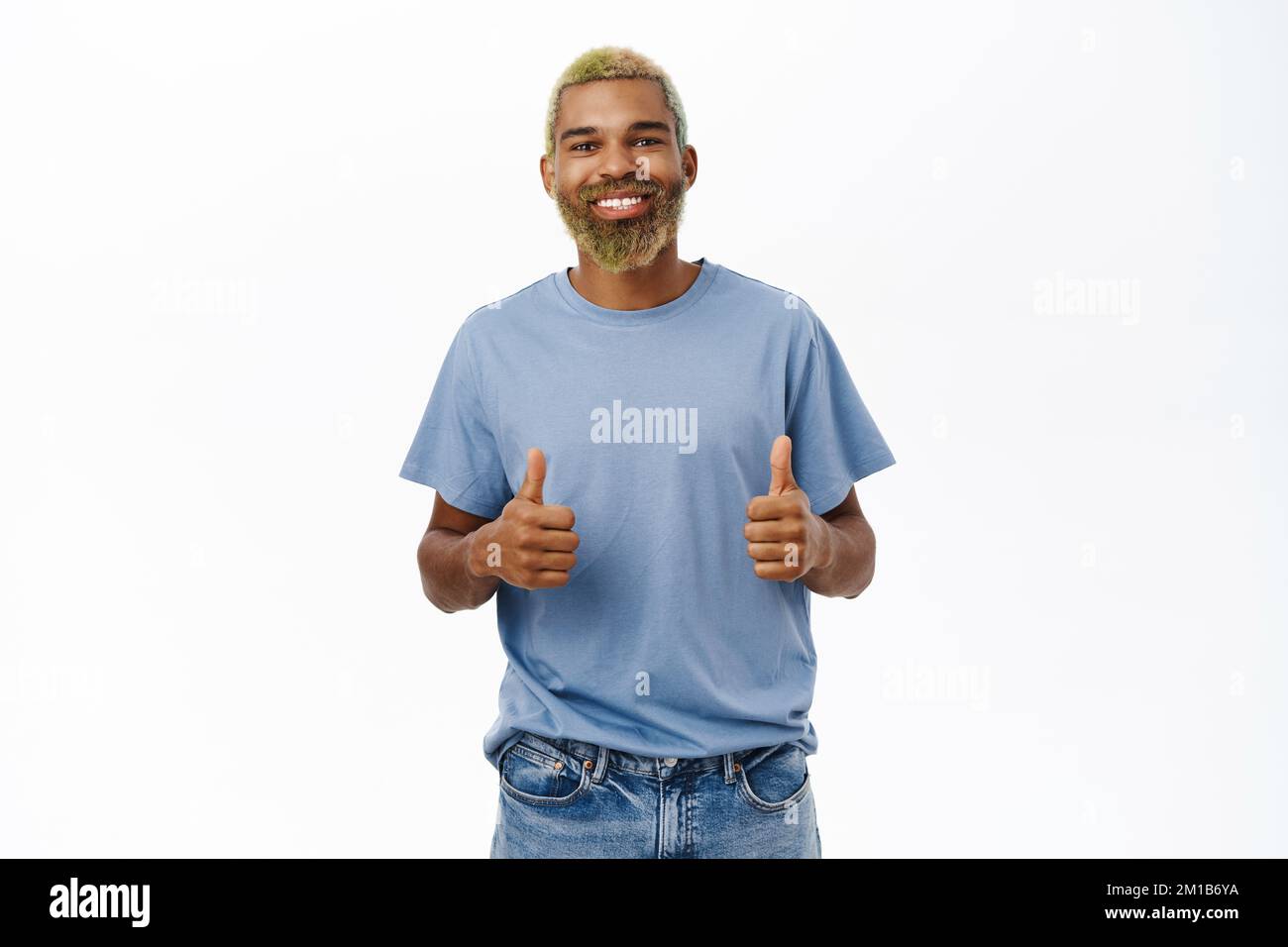 Handsome smiling modern guy, black man shows thumbs up, approves smth ...