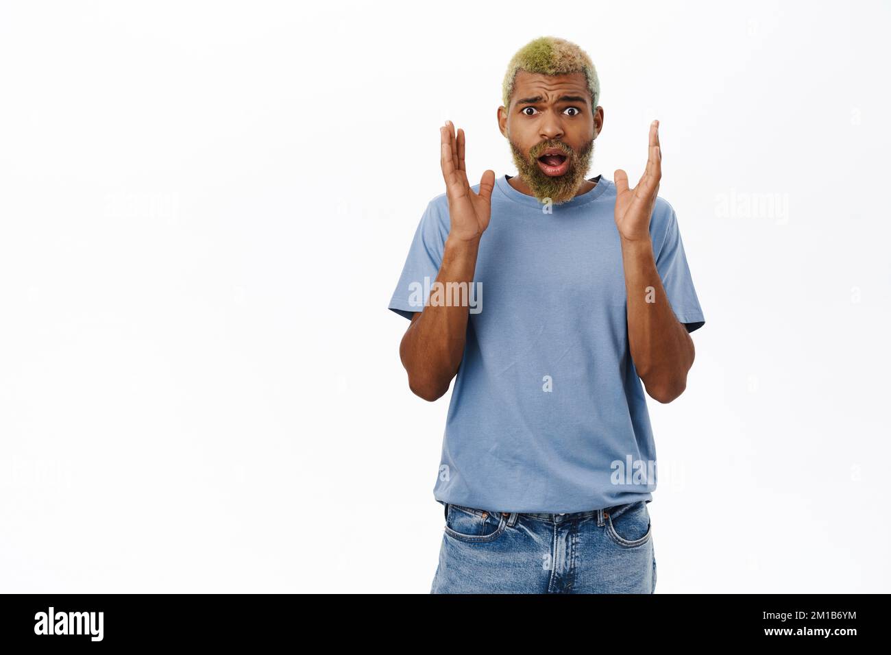 Portrait of Black man looks shocked and speechless, gasping alarmed at ...