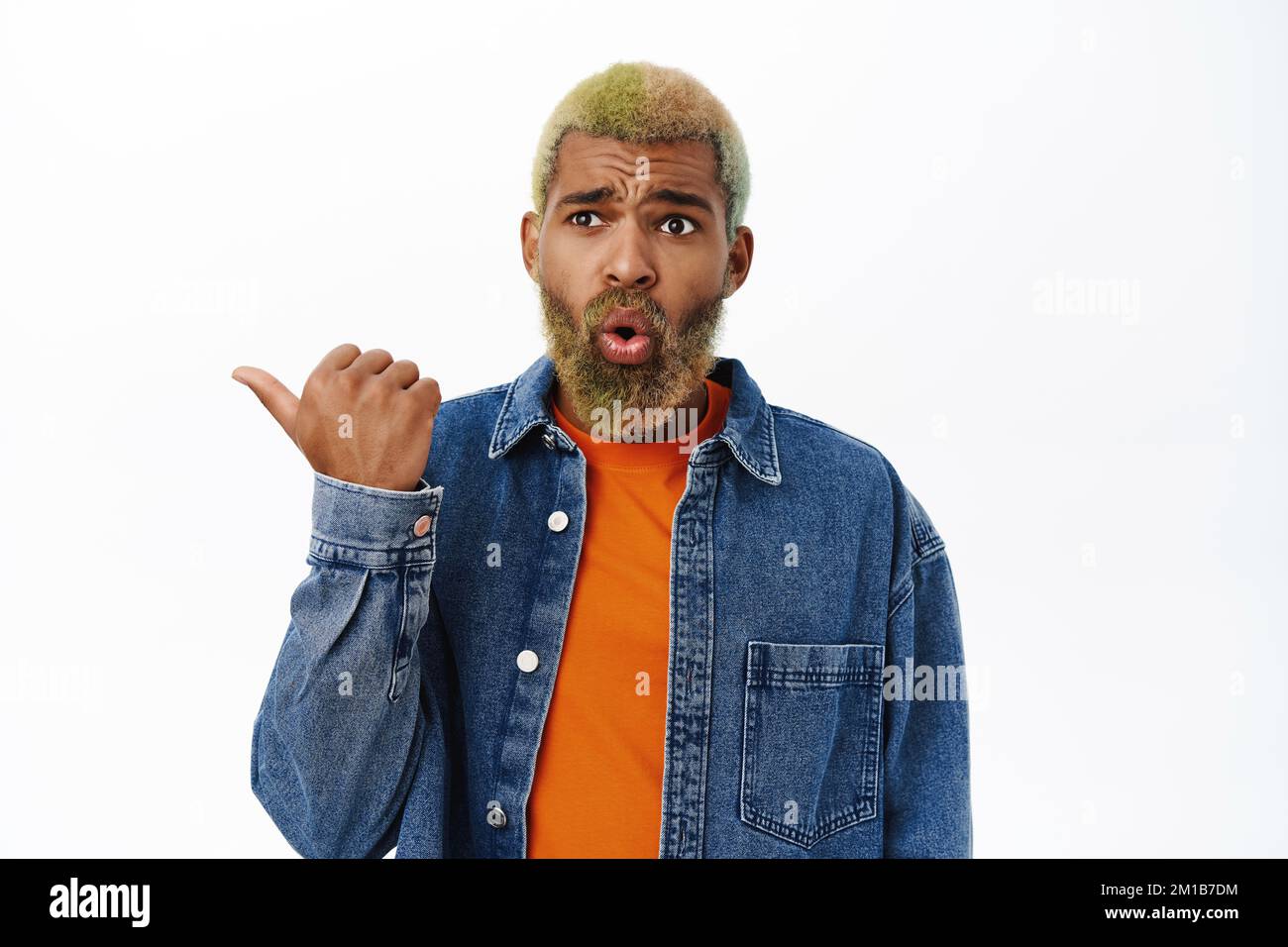Close up of shocked Black man pointing left, looking concerned and ...