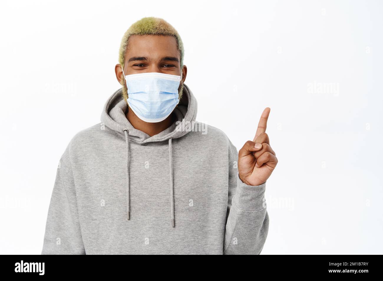 Covid 19, coronavirus concept. Smiling young black man wearing medical ...