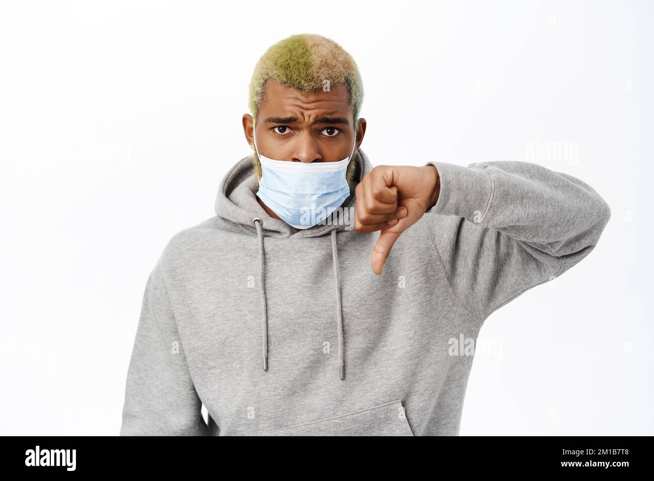 Covid 19, coronavirus concept. Black man shows wrong way of wearing ...