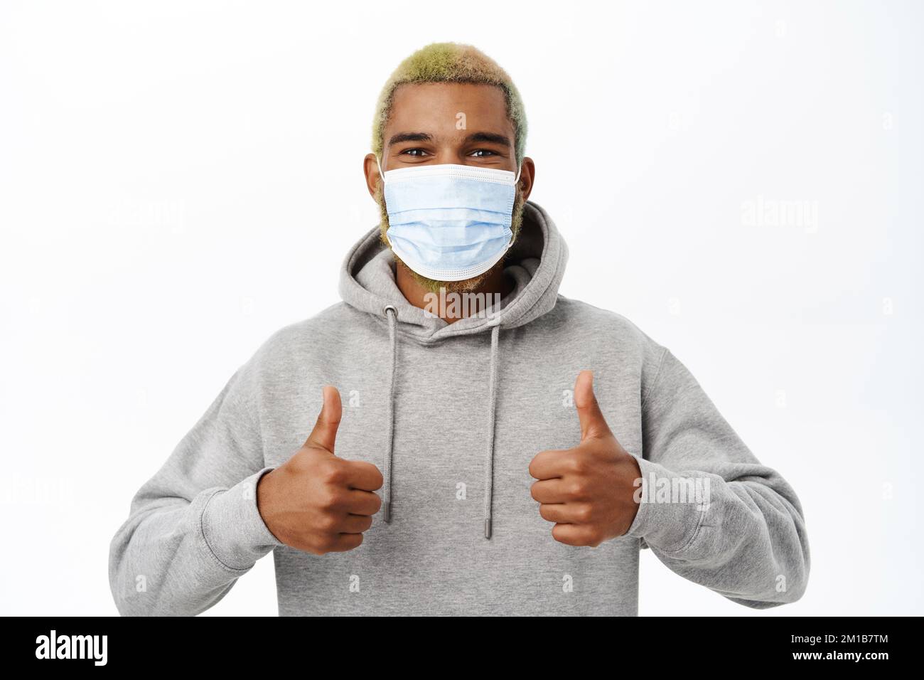 Covid 19, coronavirus concept. Smiling african american guy supports ...