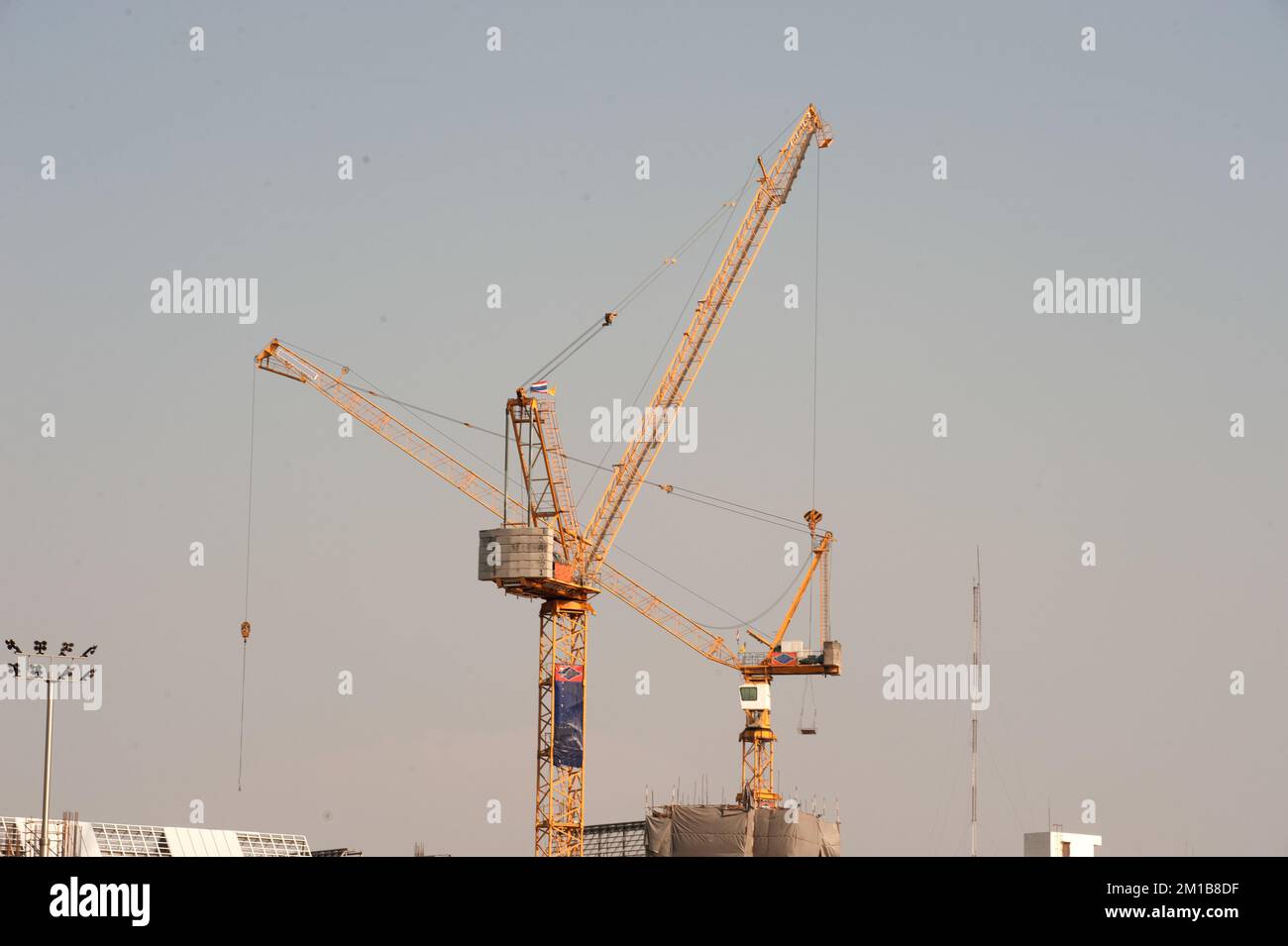 Yellow hoisting crane on construction Stock Photo - Alamy