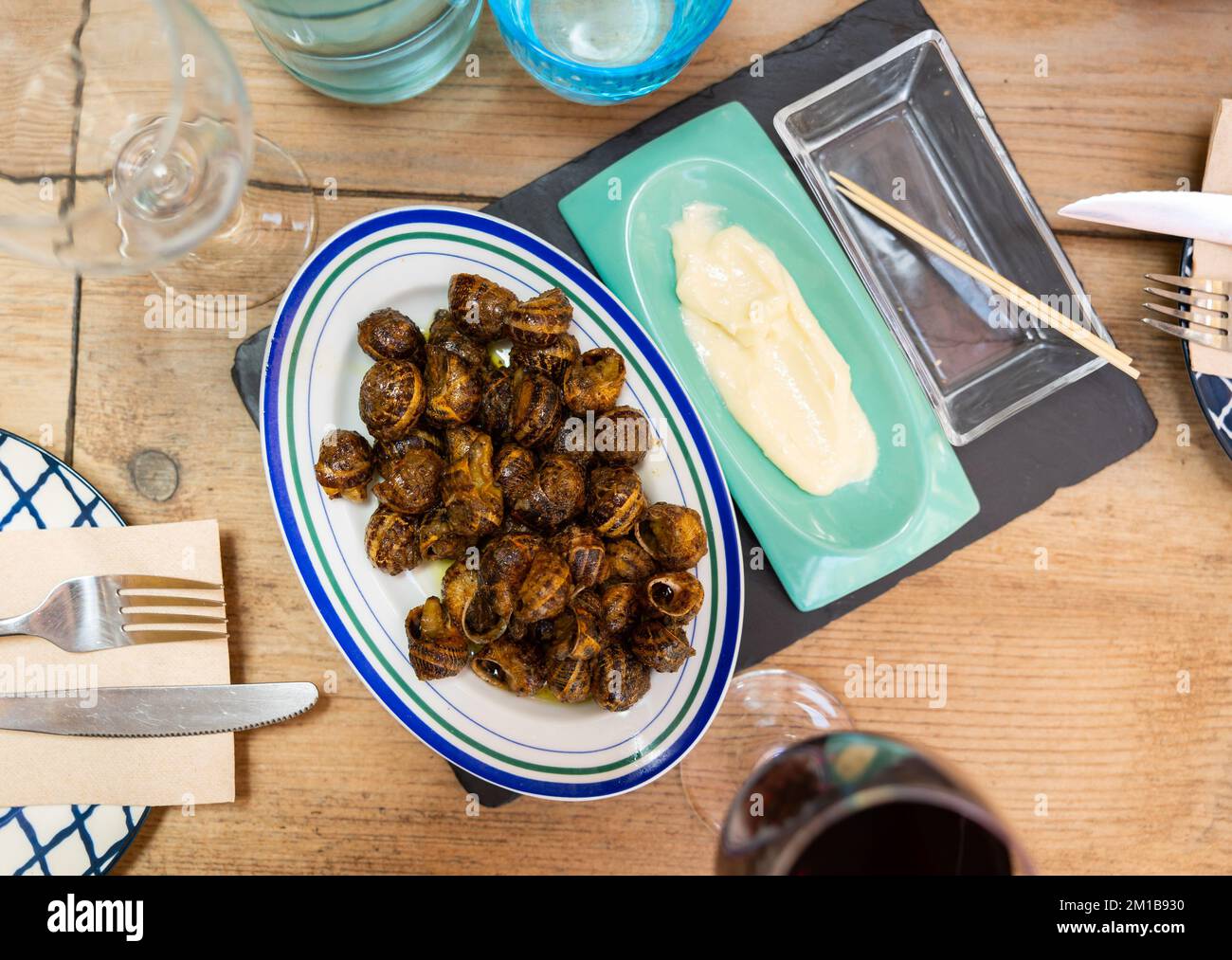 Caracoles snails grilled in shells served with spicy aioli Stock Photo ...